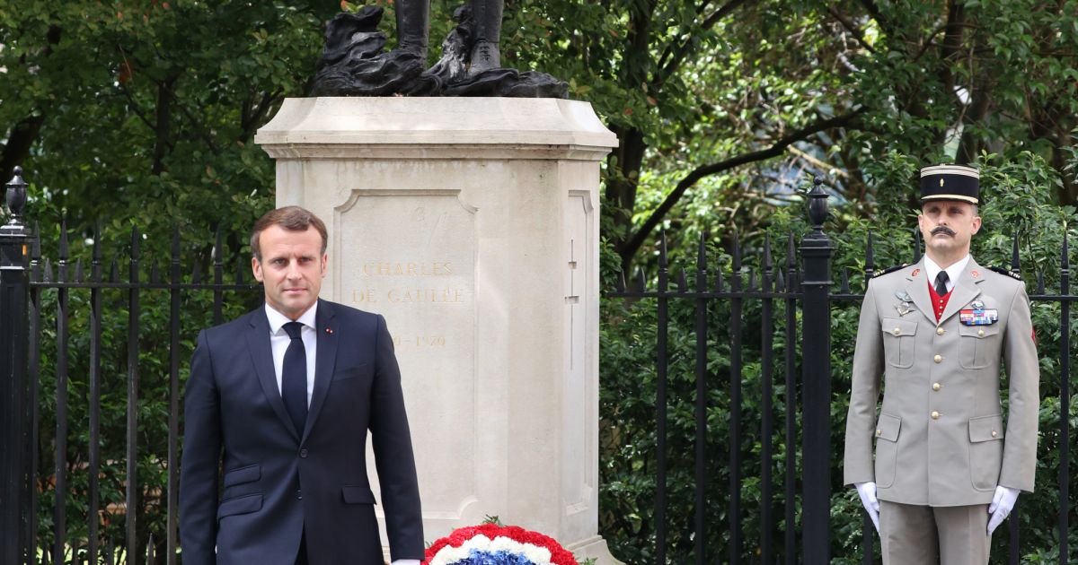 French president Emmanuel Macron lays a wreath at foot of the statues ...