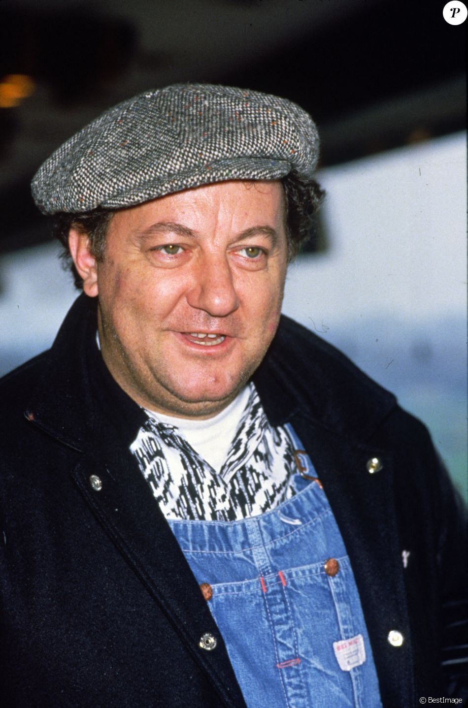 Archives - Portrait de Coluche l'année de sa mort. - Purepeople